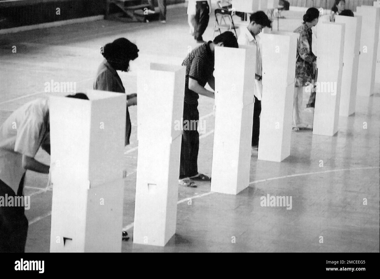 Cambodians fill the voting booths at the Phnom Penh stadium during the ...