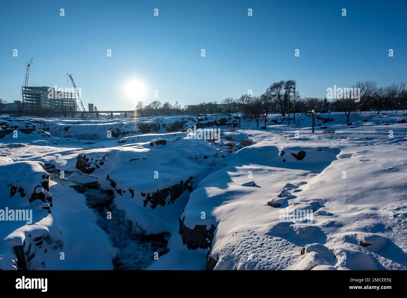 Sioux Falls Park during winter with frozen waterfall and snow cover ...