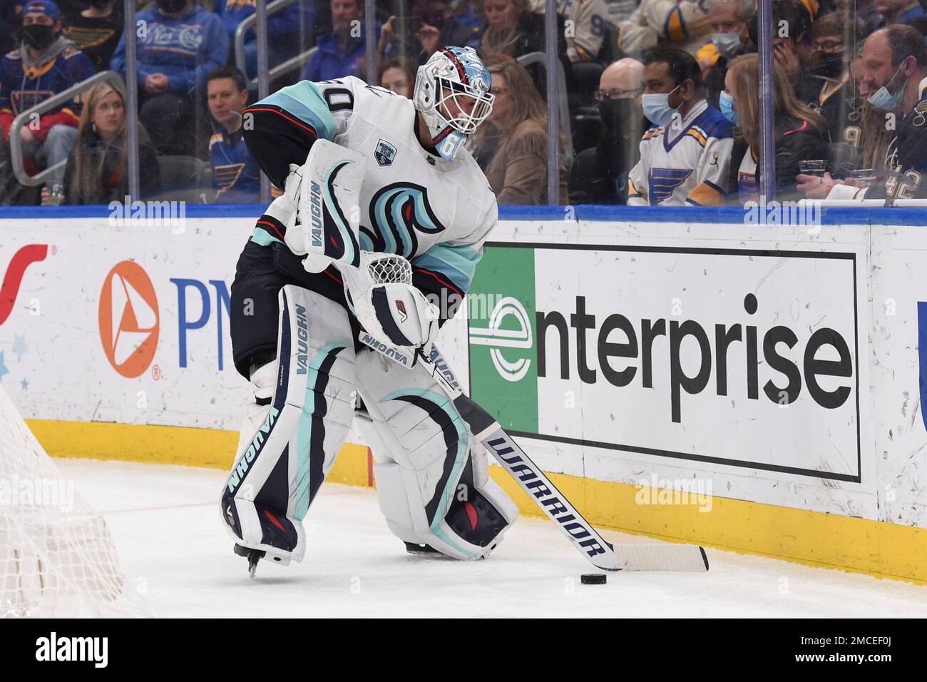 Seattle Kraken goaltender Chris Driedger (60) plays the puck against ...