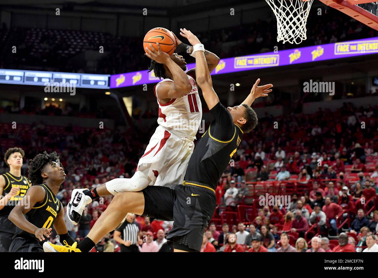 Arkansas guard Davonte Davis (4) drives past Missouri guard Javon ...