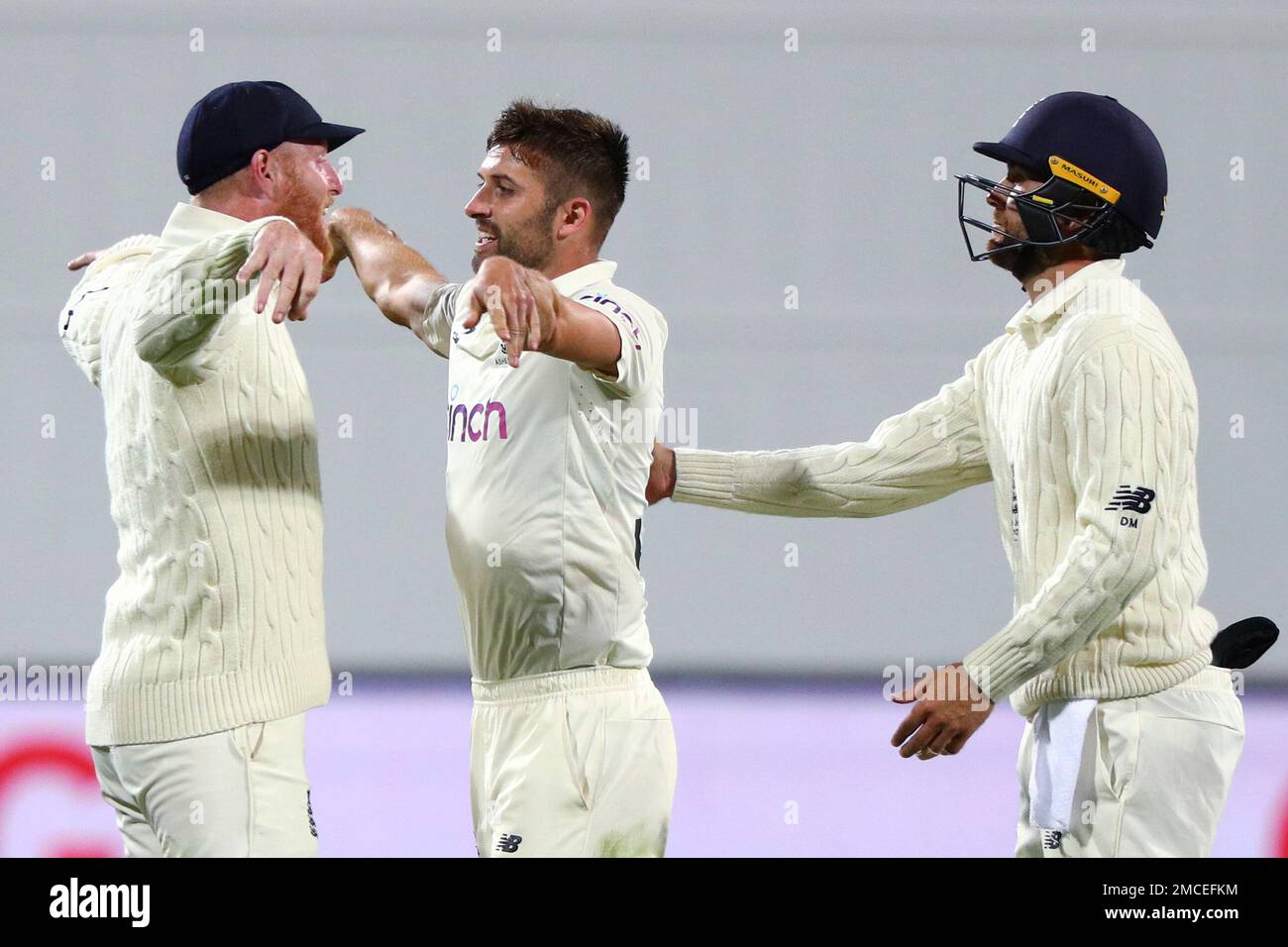 England's Mark Wood, center, celebrates with teammates after taking the ...