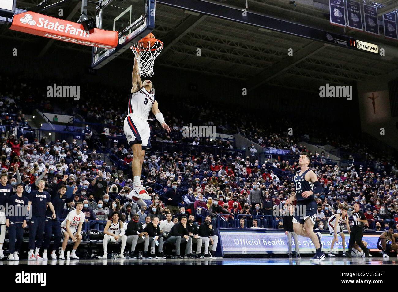 Gonzaga guard Andrew Nembhard (3) dunks in front of BYU guard Alex ...