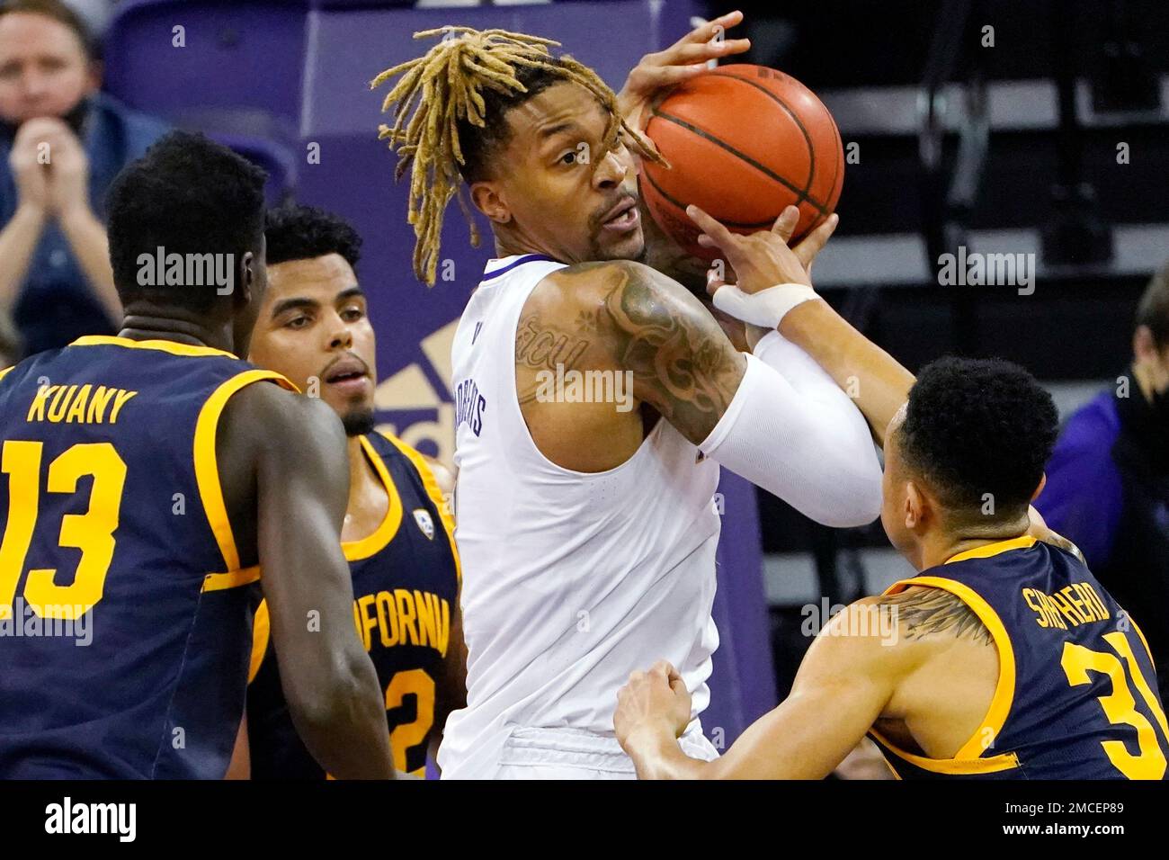 Washington's Nate Roberts, center, grabs a rebound against California ...