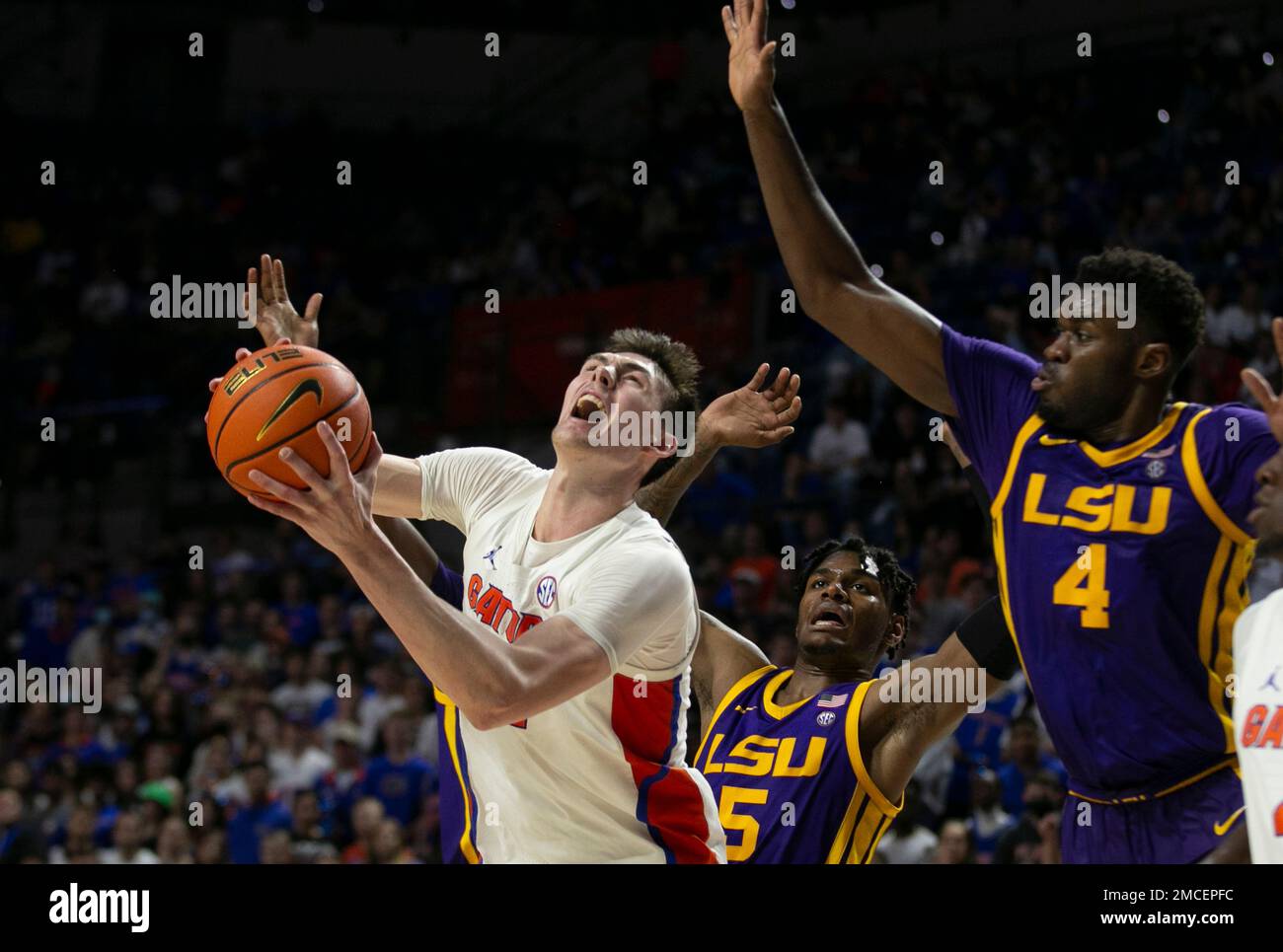 Florida forward Colin Castleton, left, drives through LSU forwards ...