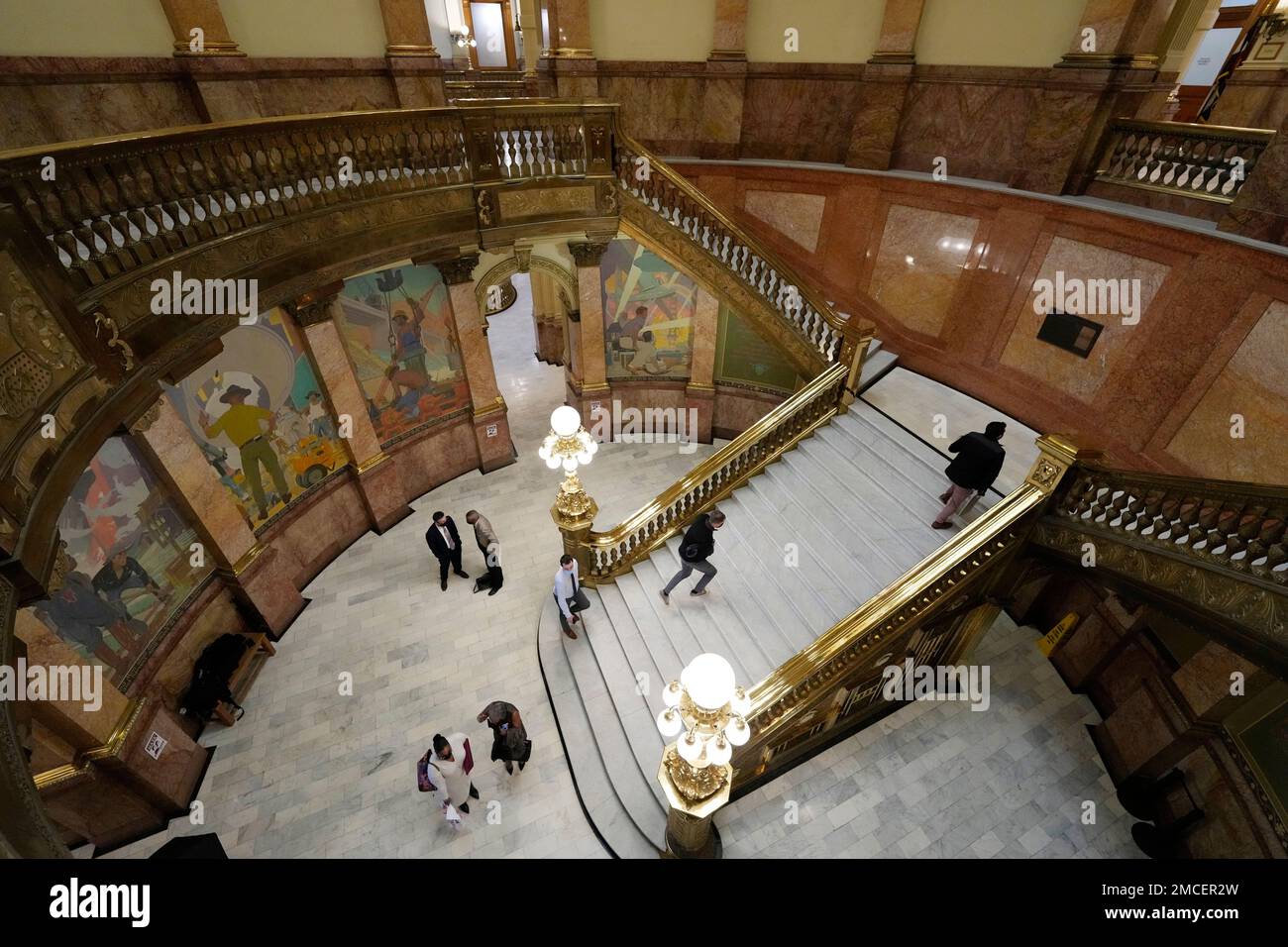 Visitors and lawmakers climb the stairs in the rotunda of the Colorado ...