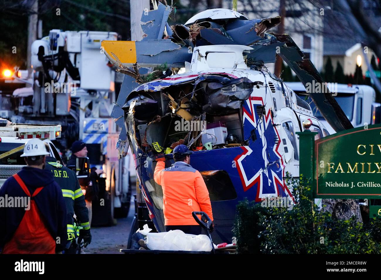 A crashed medical helicopter is removed from the scene in the Drexel ...
