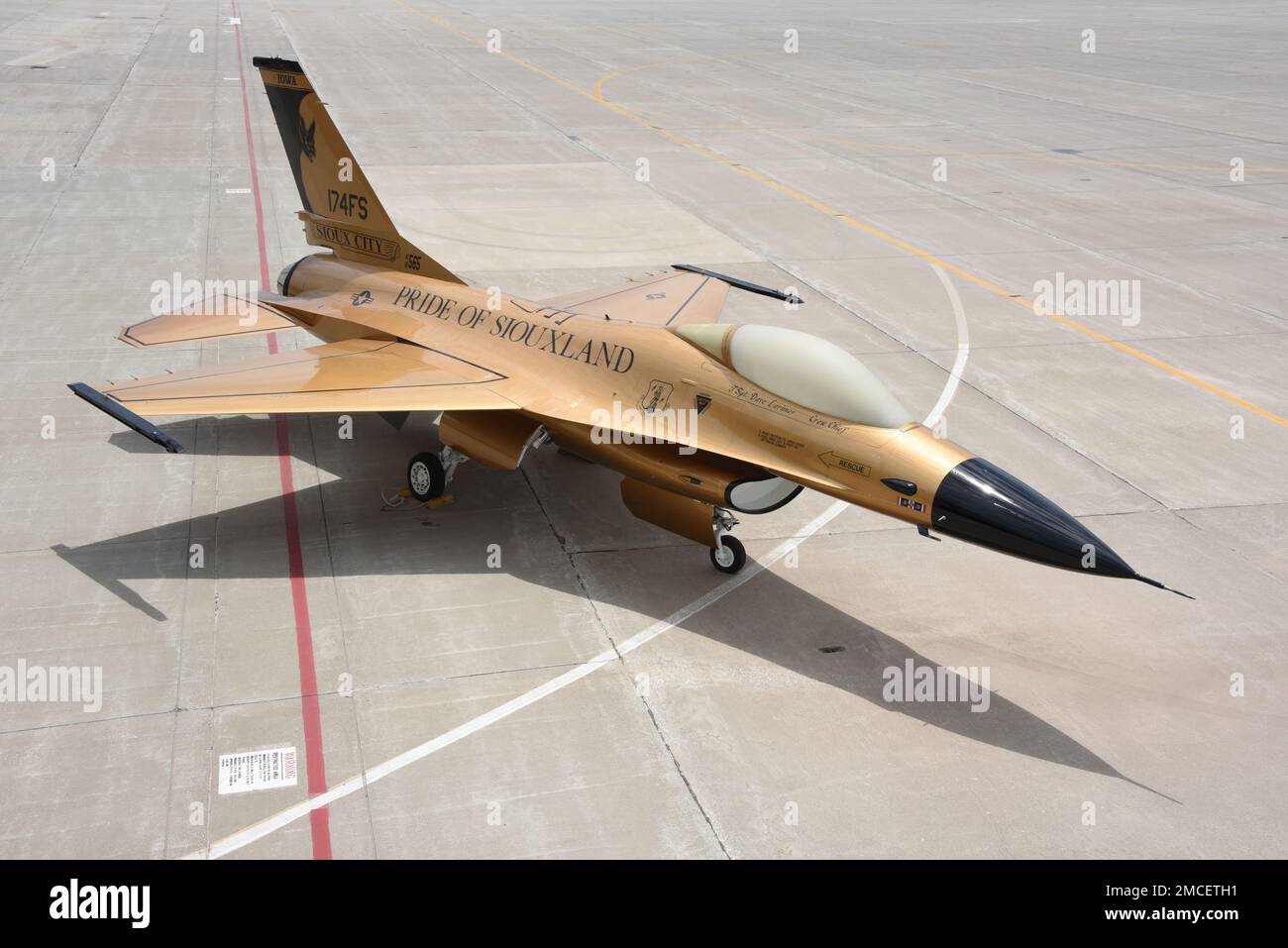 A gold U.S. Air Force F-16A Falcon from the Iowa Air National Guard is ...