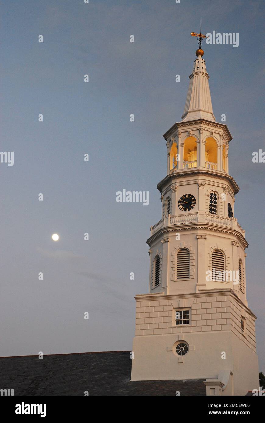 The tall white steeple of St Michael's Church sits under a full moon in ...