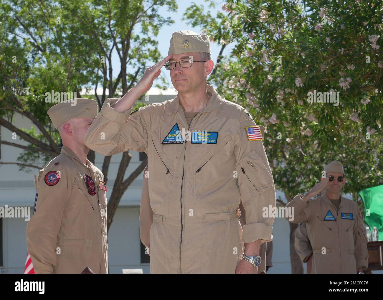 Rear Adm. Keith Hash, a native of Garland, Texas, salutes as he is ...