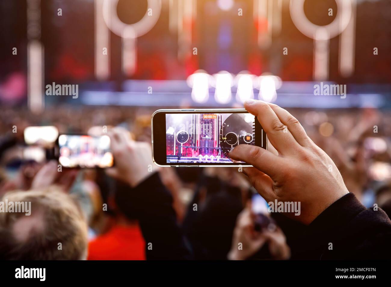 Taking photos of a rock concert on the mobile phone, open-air festival ...