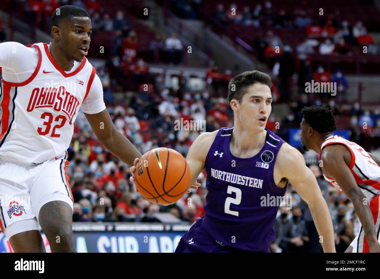 Northwestern guard Ryan Greer, right, drives in front of Ohio State ...