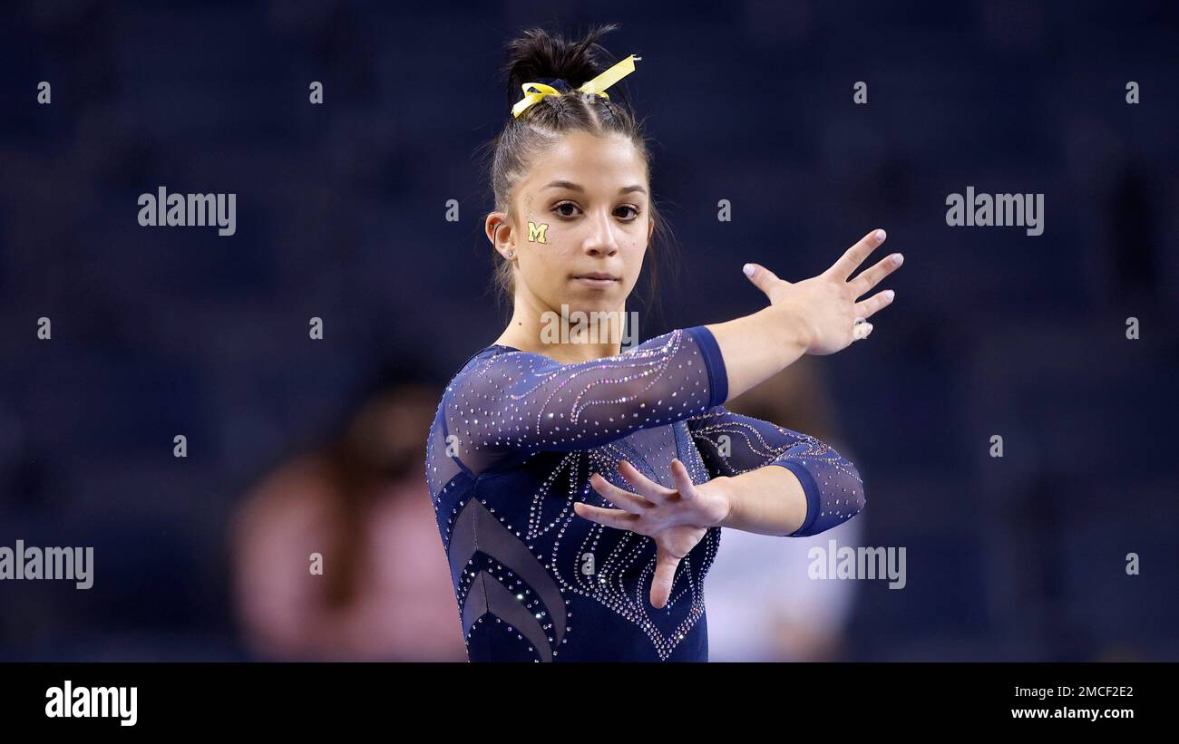 Michigan's Reyna Guggino performs on the beam during an NCAA gymnastics ...