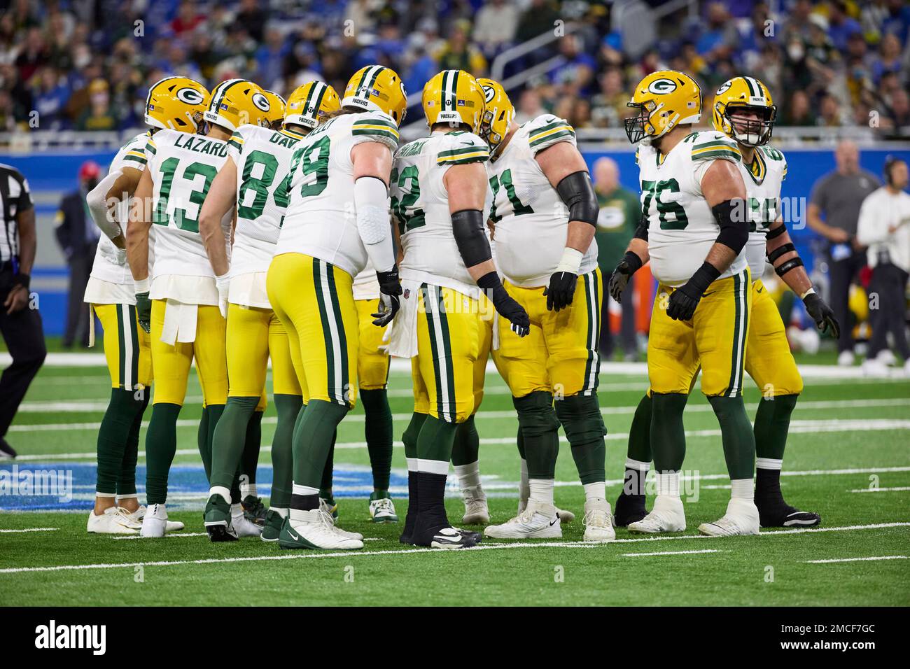 Green Bay Packers huddle up on offense against the Detroit Lions during an NFL football game ...
