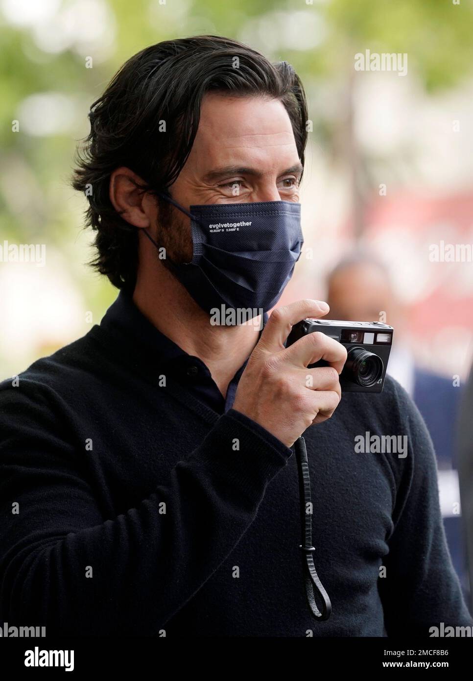 Actor Milo Ventimiglia takes pictures during a ceremony to award him a ...