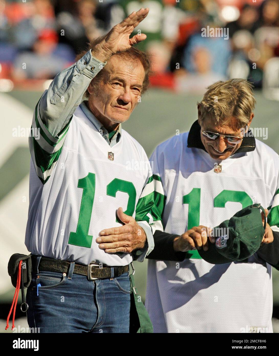 FILE - Hall of Fame wide receiver Don Maynard, left, waves to fans as ...