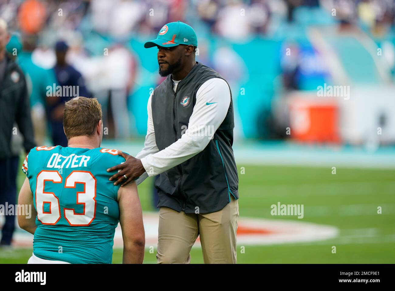 Miami Dolphins head coach Brian Flores talks with Miami Dolphins center ...