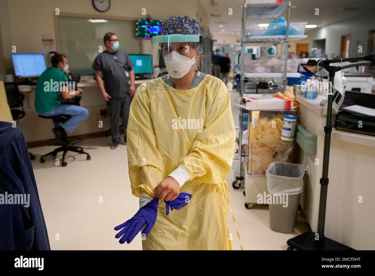 Registered nurse Morgan Flynn prepares to enter a patient's room in the ...
