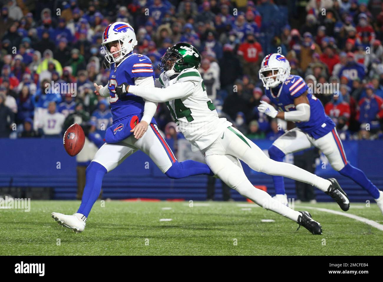 Buffalo Bills punter Matt Haack, left, attempts to punt while being ...