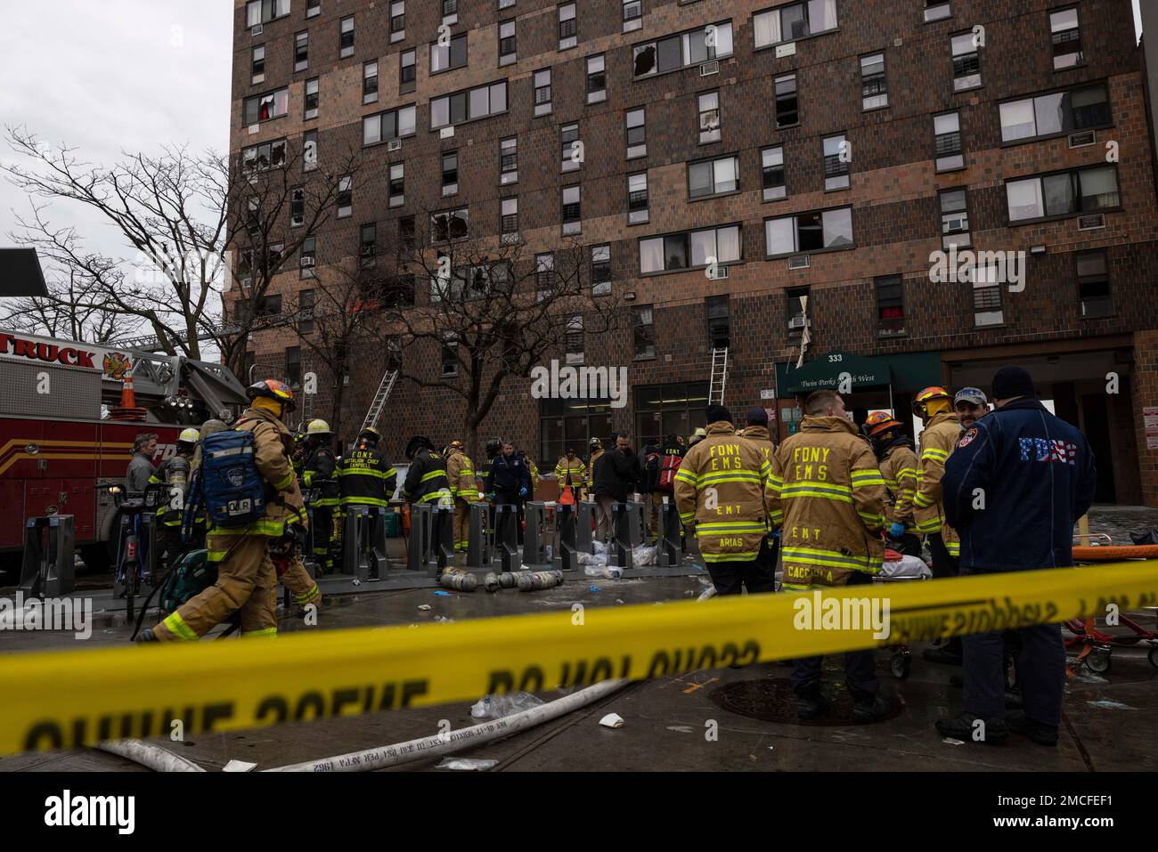 Emergency personnel work at the scene of a fatal fire at an apartment ...