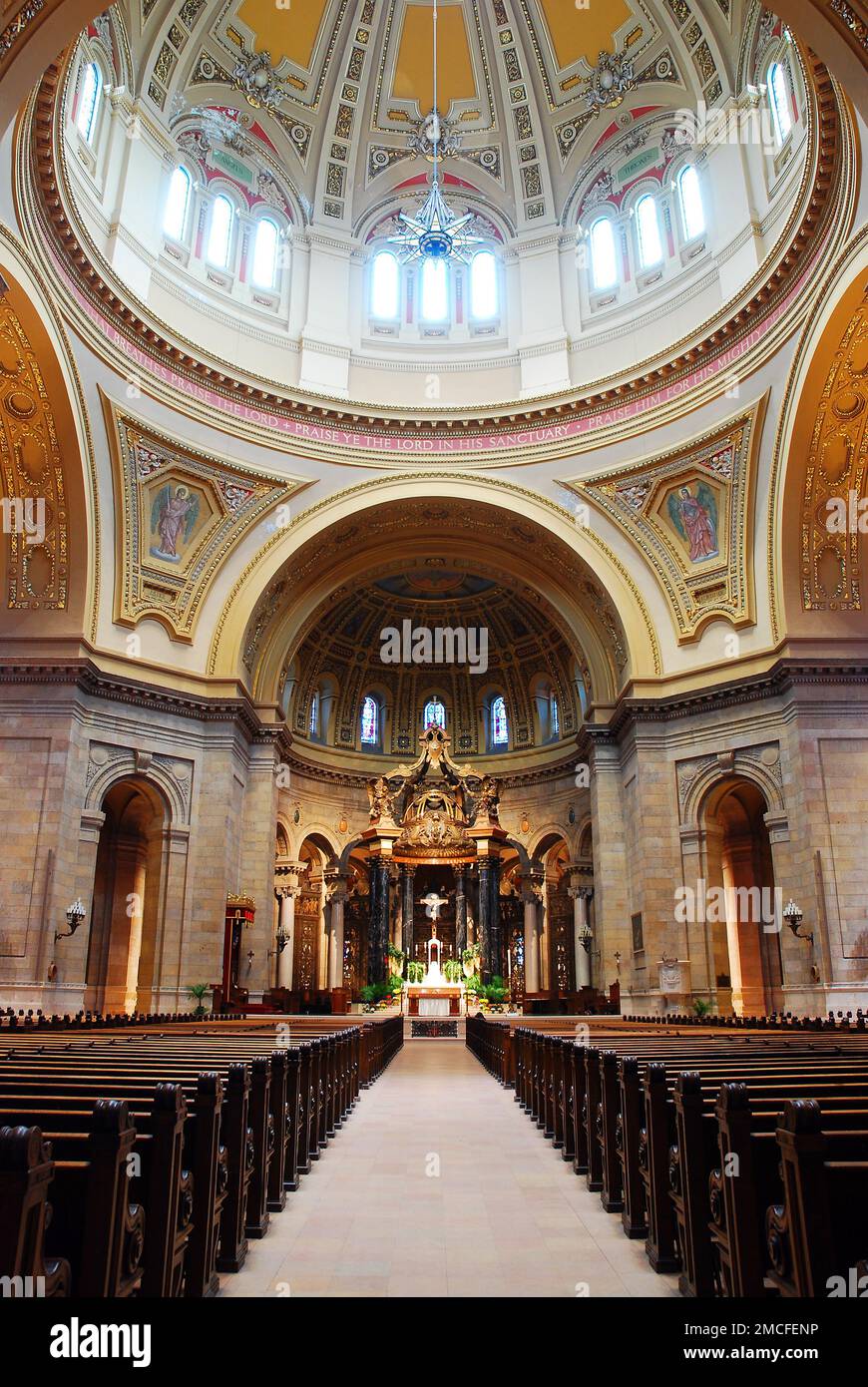 An aisle leads between the pews and towards the altar in the Interior ...