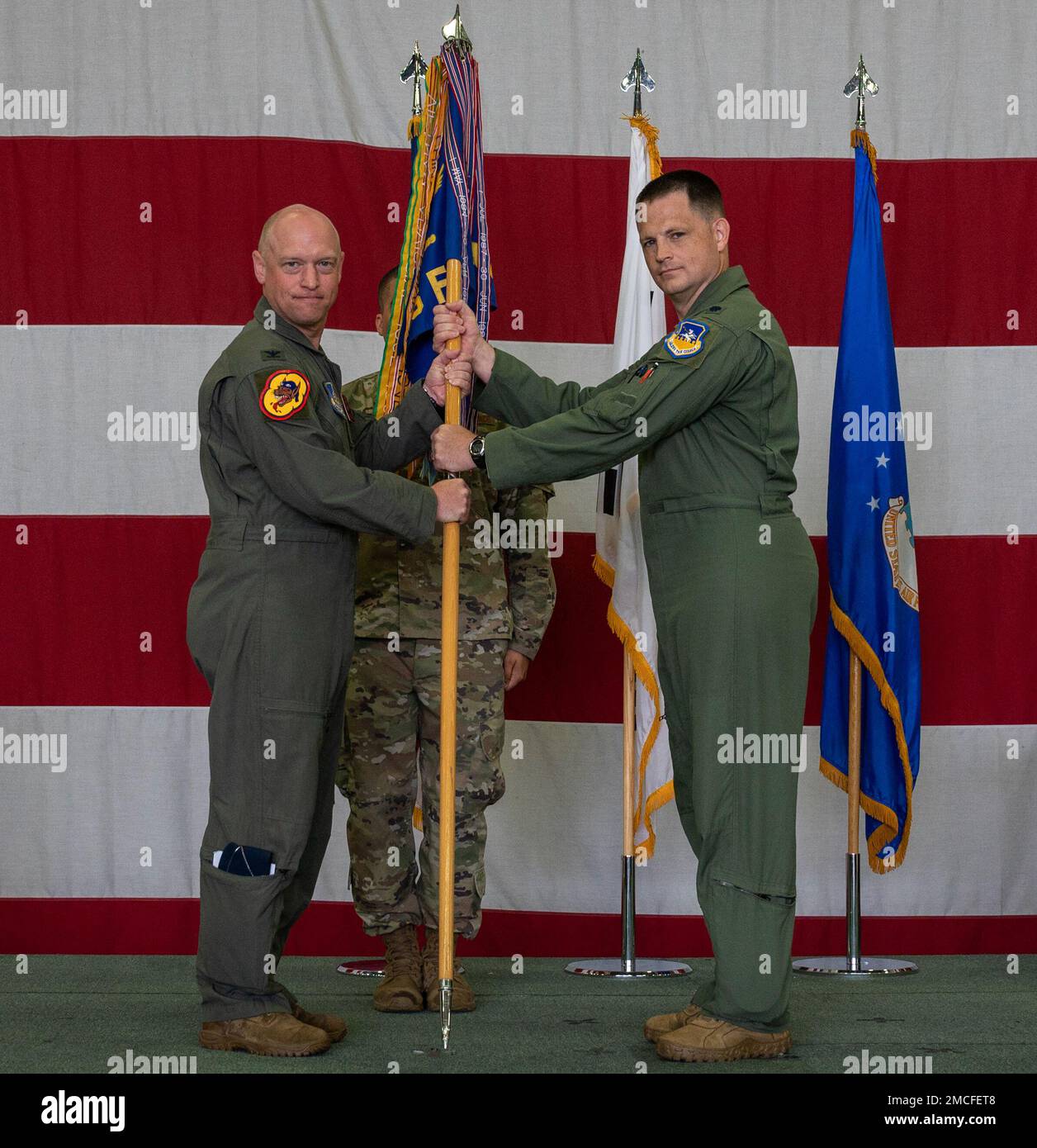 Col. Mathew Gaetke, 51st Operations Group commander, left, passes the ...