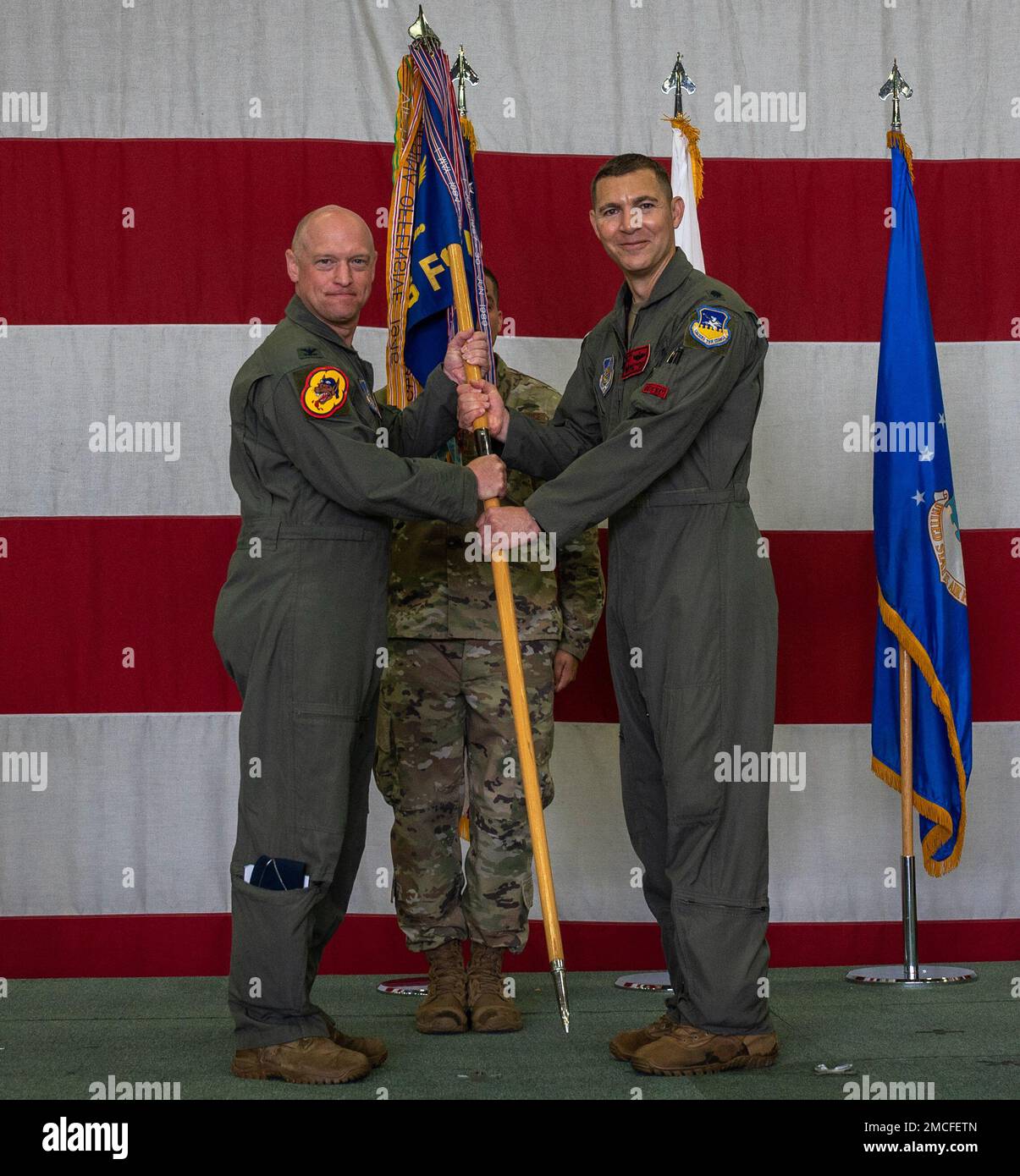 Col. Mathew Gaetke, 51st Operations Group commander, left, receives the ...