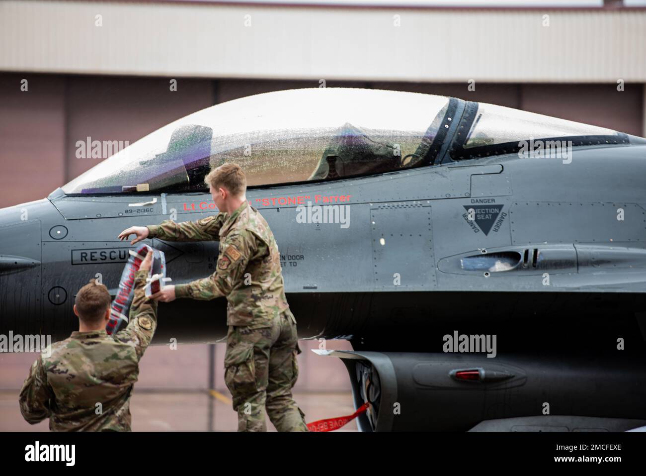 Airmen assigned to the 36th Fighter Squadron reveal a name tape on an F ...