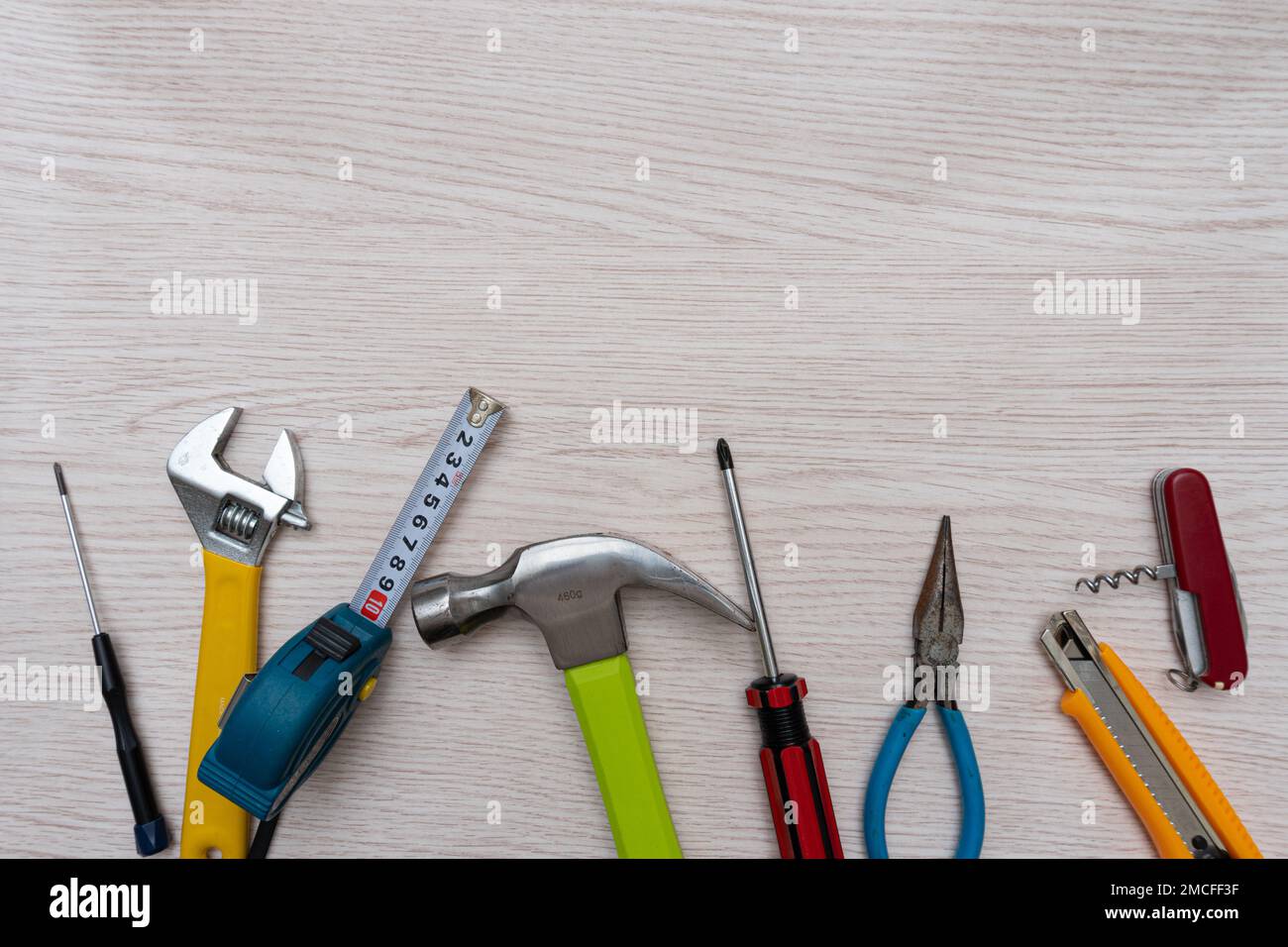 Various household tools such as hammer and tape measure screwdriver ...