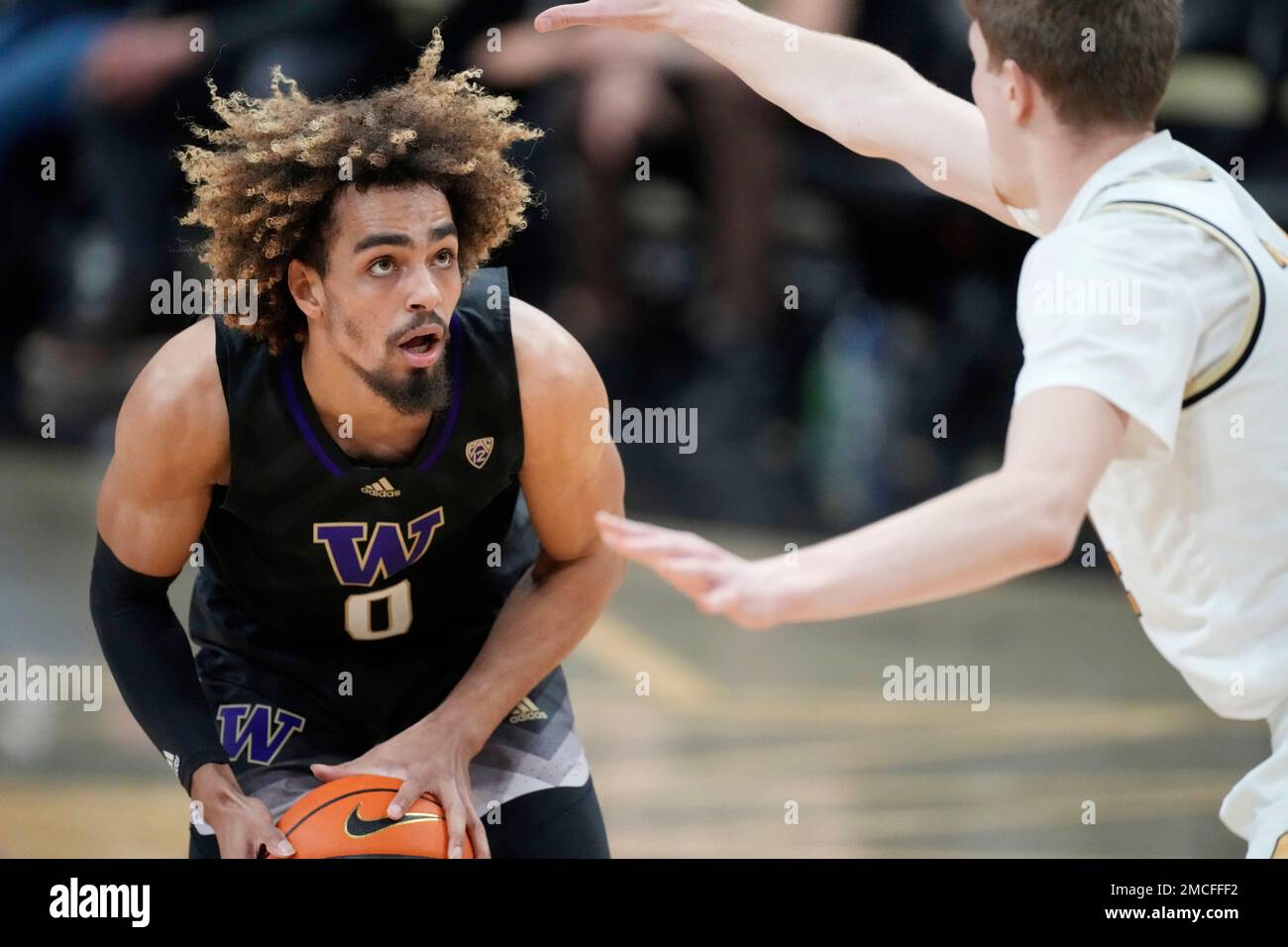 Washington forward Emmitt Matthews Jr., left, looks to drive the lane ...