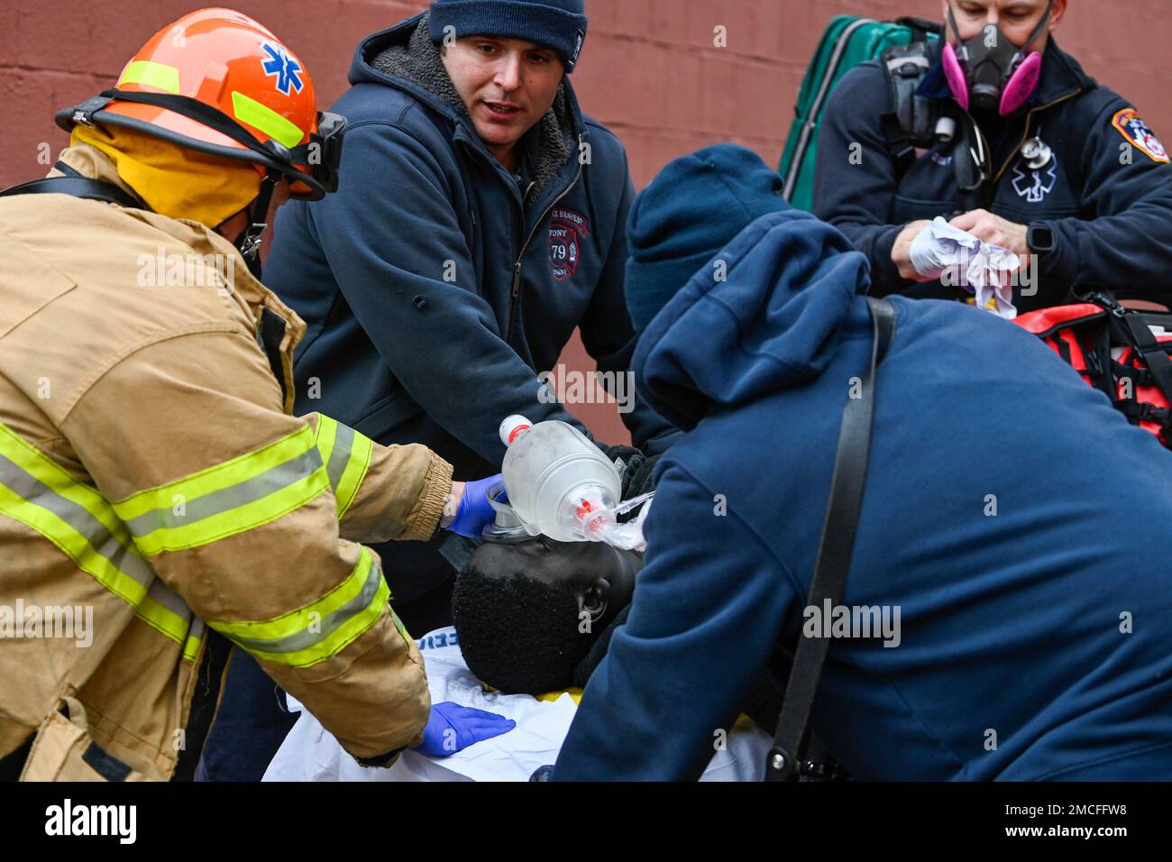 Emergency personnel perform CPR on a fire victim during a high rise ...