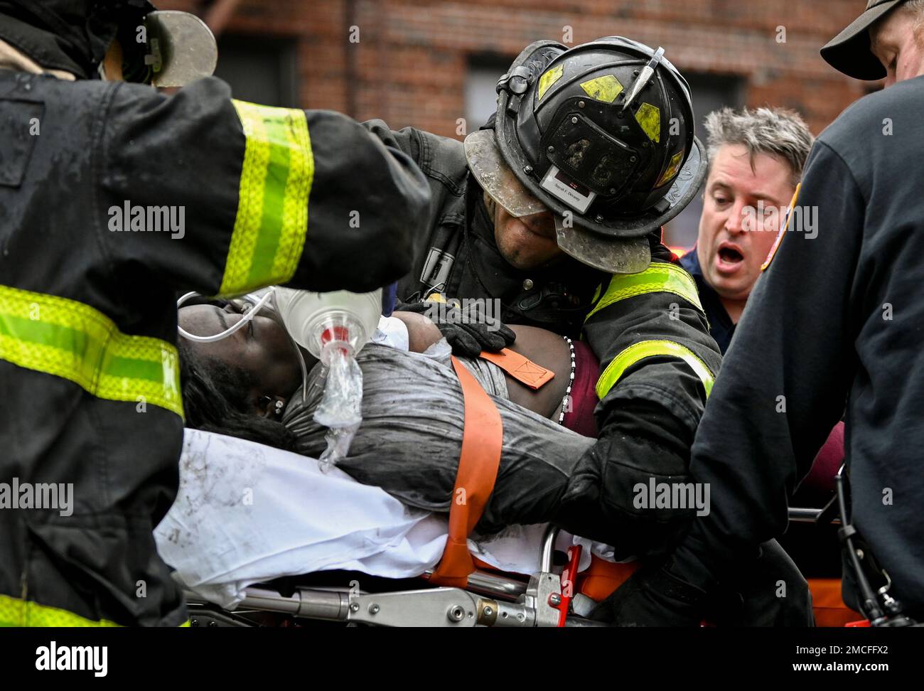Emergency personnel perform CPR on a fire victim of a high rise fire on ...