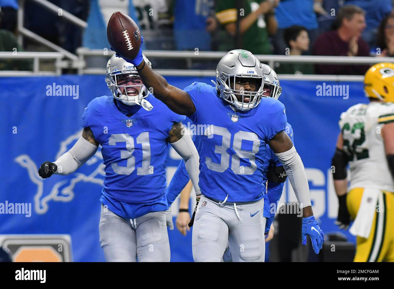 Detroit Lions defensive back C.J. Moore holds the ball aloft during the ...