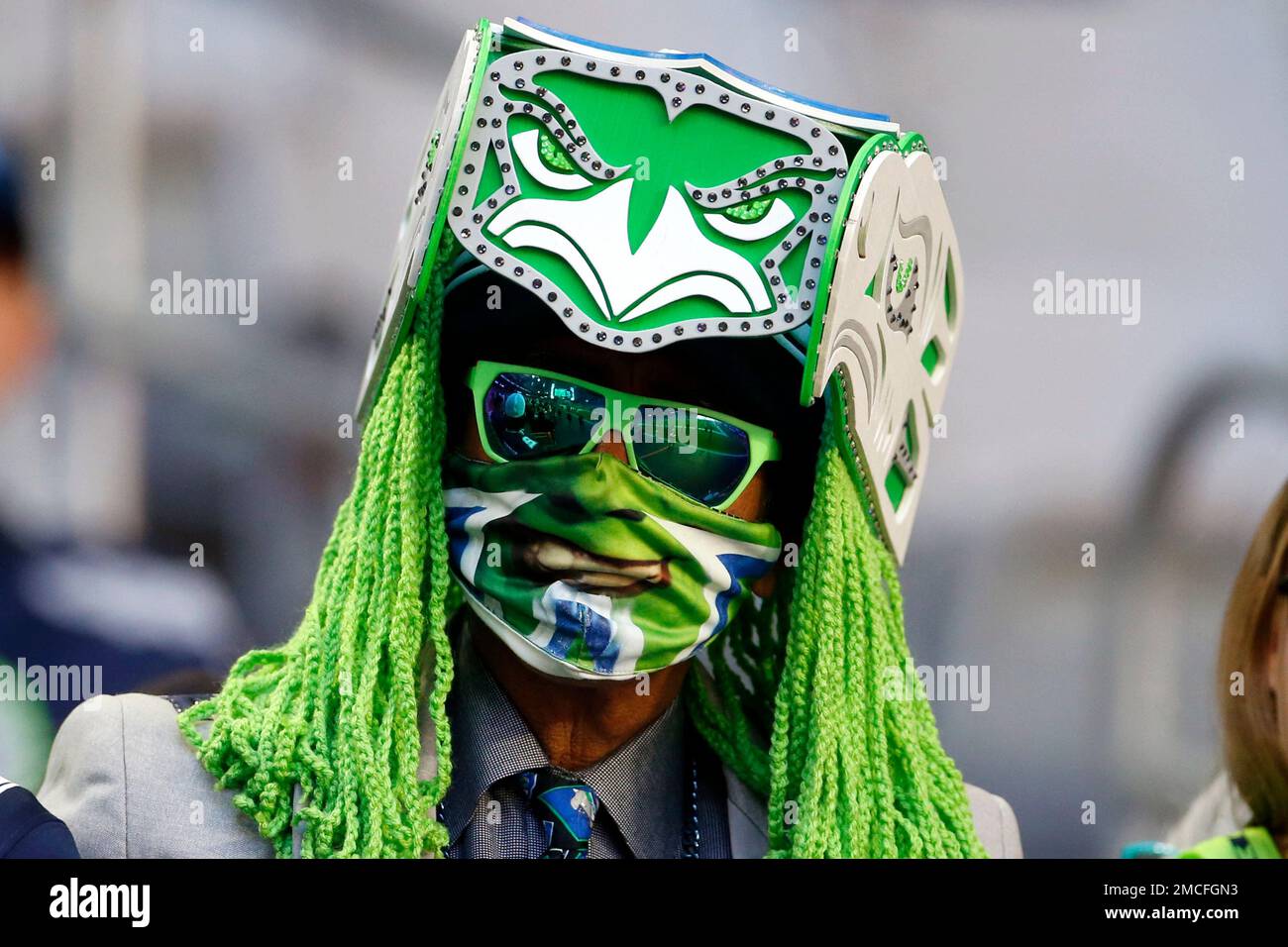 A Seattle Seahawks fan watches the Seahawks warm prior to an NFL ...