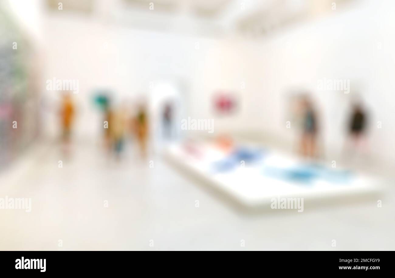 Spectator looking at paintings and sculpture in Art exhibition gallery ...