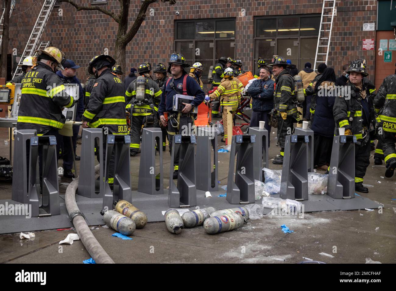 Firefighters work at the scene of a fatal fire at an apartment building ...
