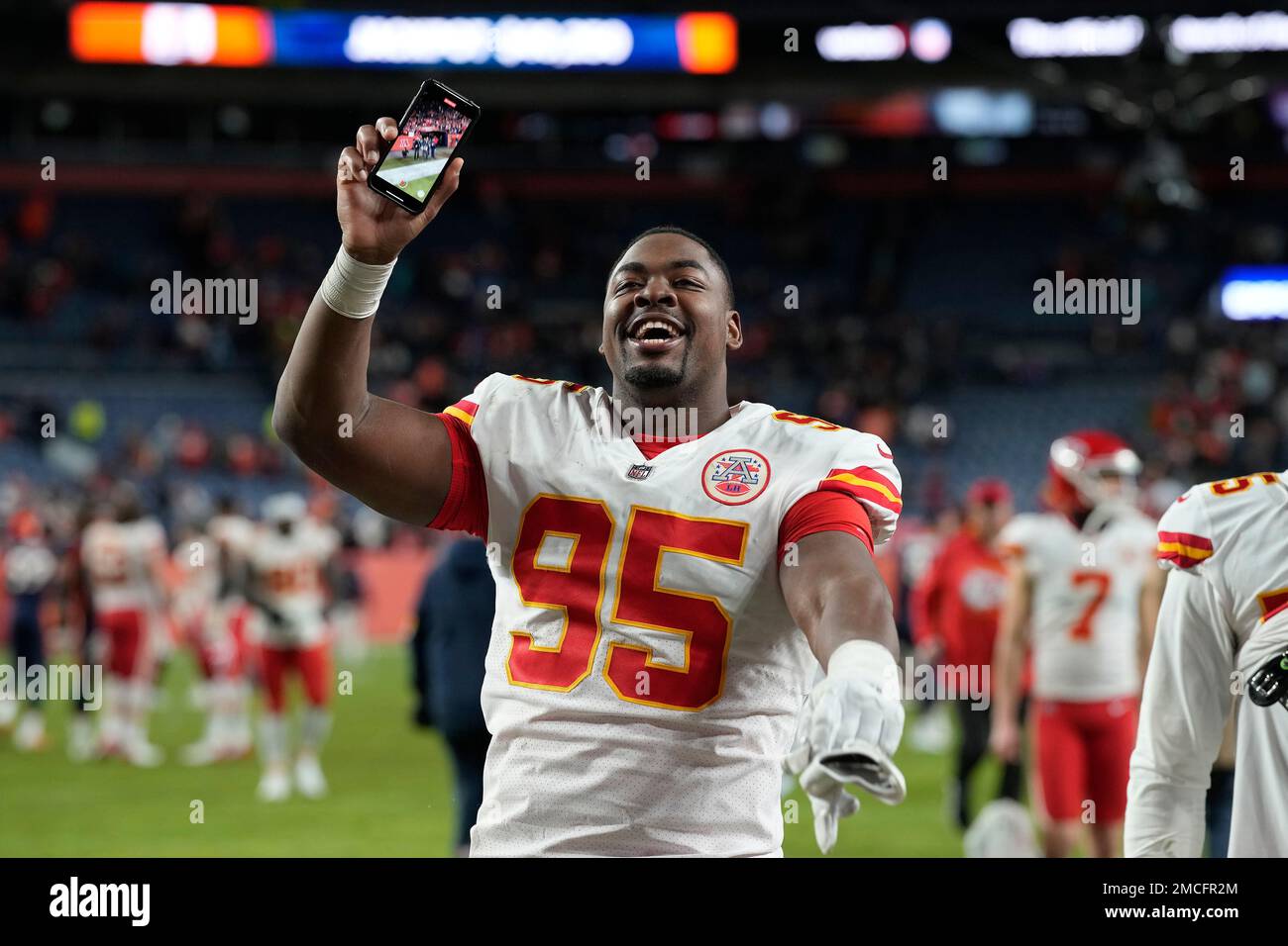 Kansas City Chiefs defensive end Chris Jones (95) holds up his phone ...