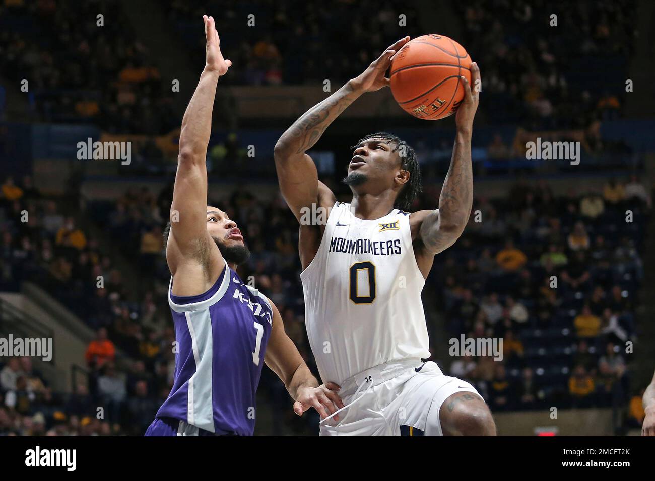 West Virginia guard Kedrian Johnson (0) shoots over Kansas State guard ...