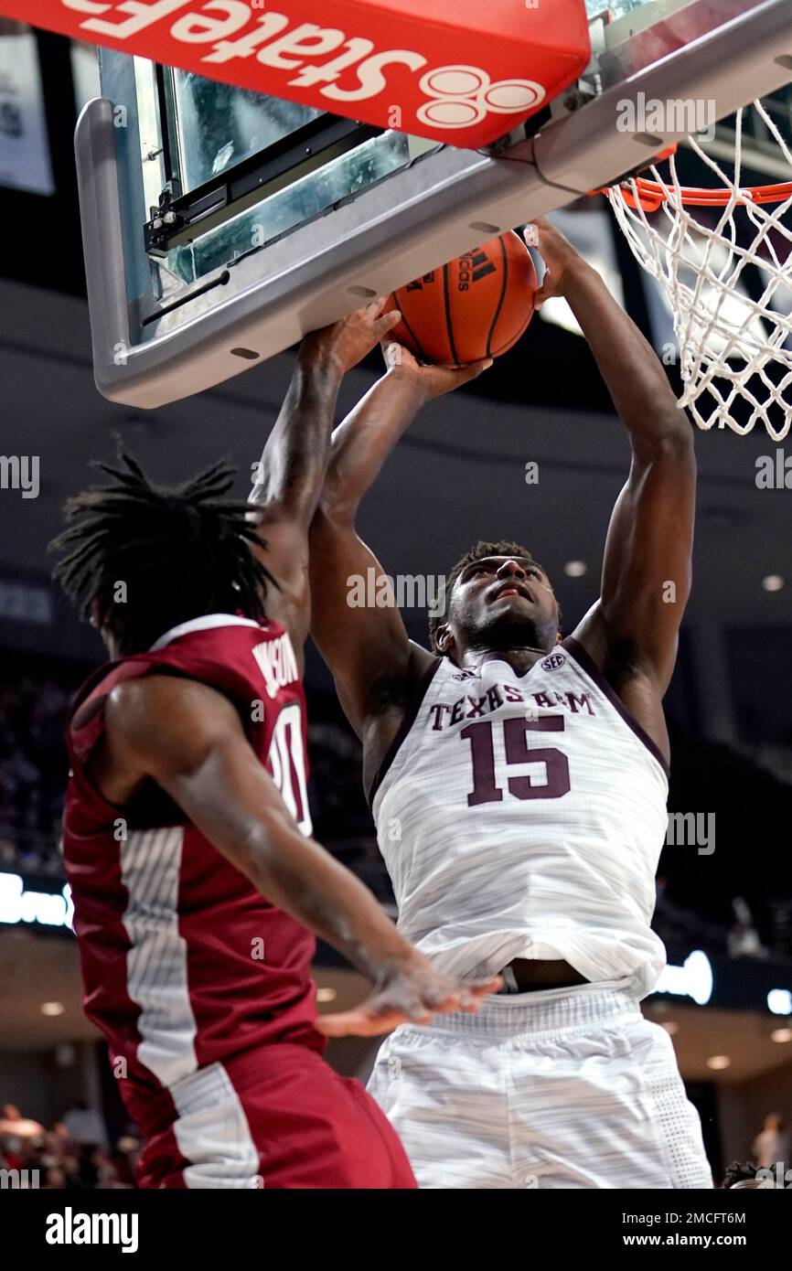 Texas A&M forward Henry Coleman III (15) makes a basket as Arkansas forward Kamani Johnson (20 ...