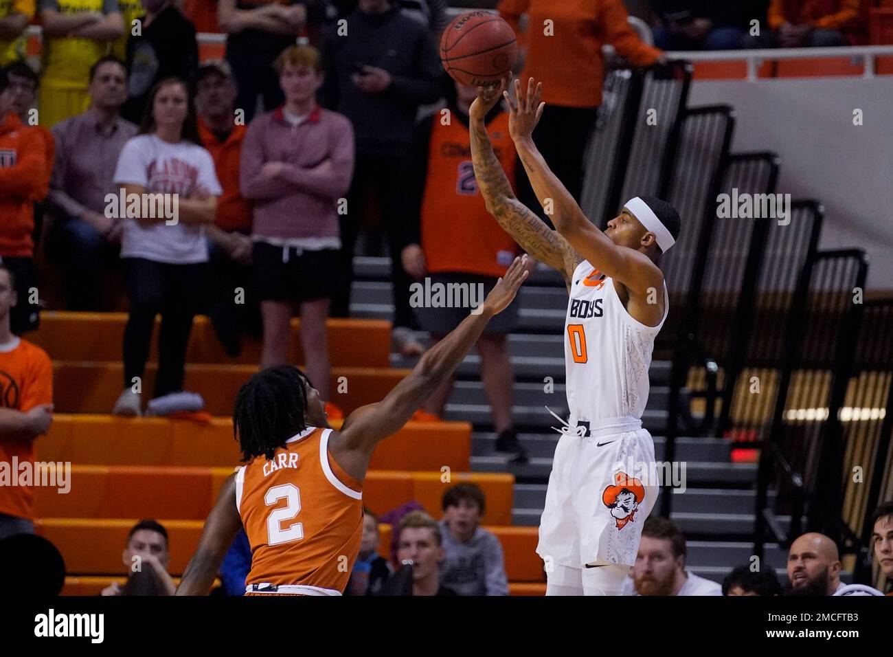 Oklahoma State guard Avery Anderson III (0) shoots over Texas guard Marcus Carr (2) in the first ...