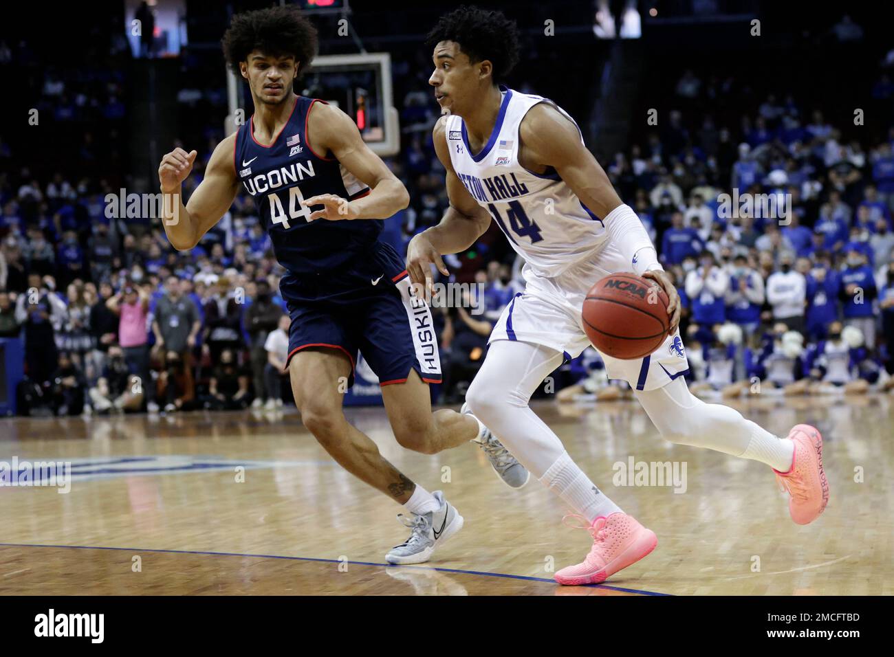 Seton Hall guard Jared Rhoden (14) drives past Connecticut guard Andre ...