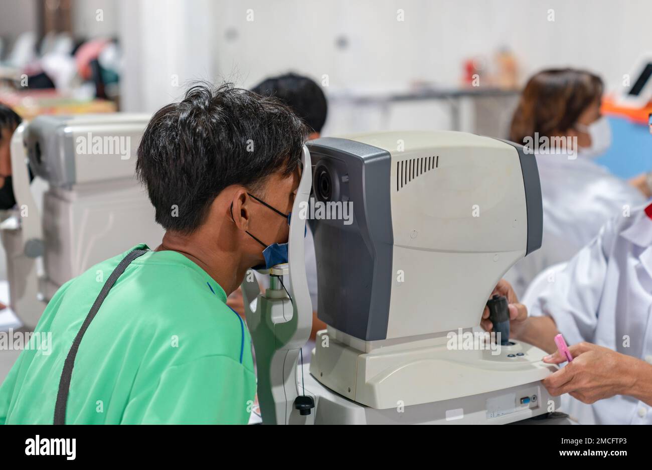 Optometrist checking patient eyesight and vision correction in annual ...