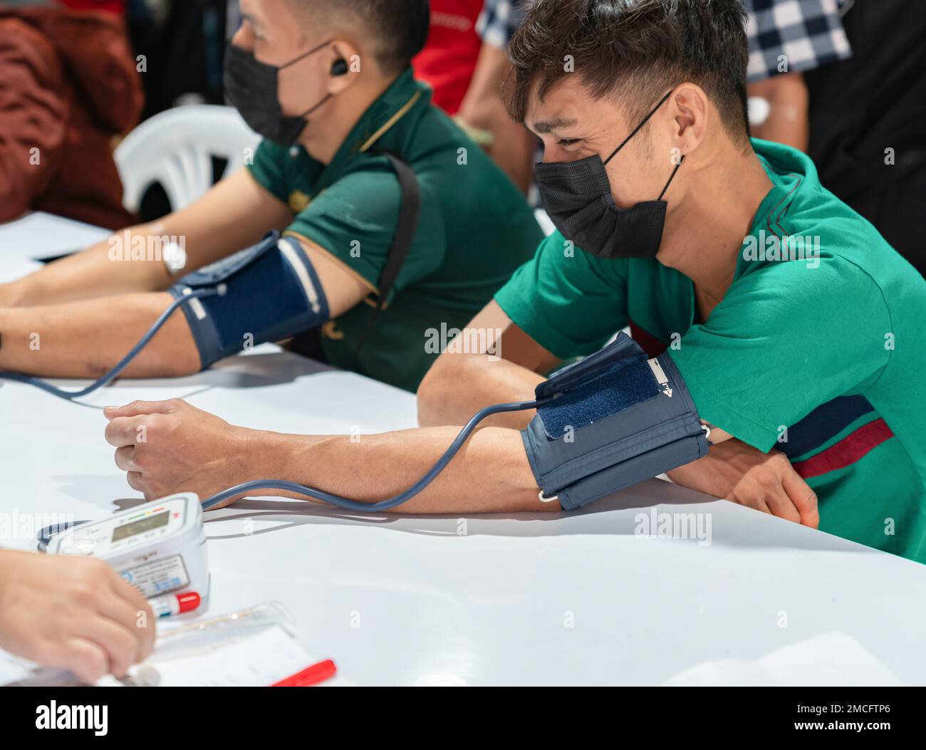 Close up young man has blood pressure checked in annual health check ...