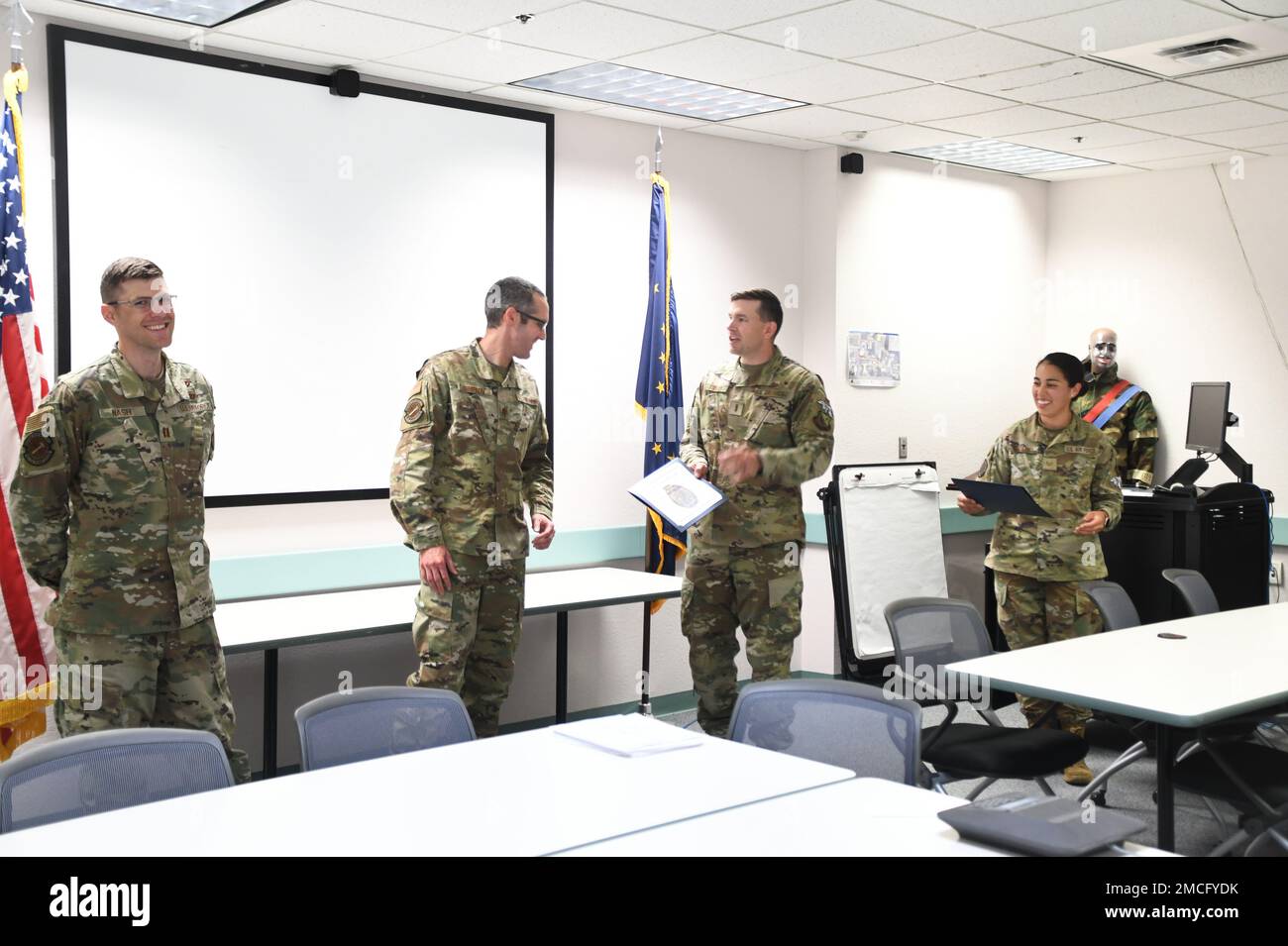 Lt. Wesley Stakely of the 168th Comptroller Flight, right, presents the ...