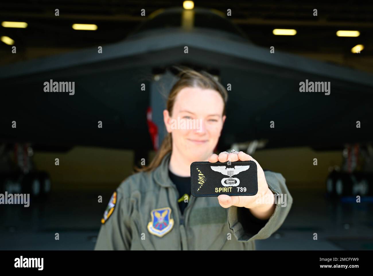 A U.S. Air Force B-2 Spirit pilot holds Spirit number patch for photo ...