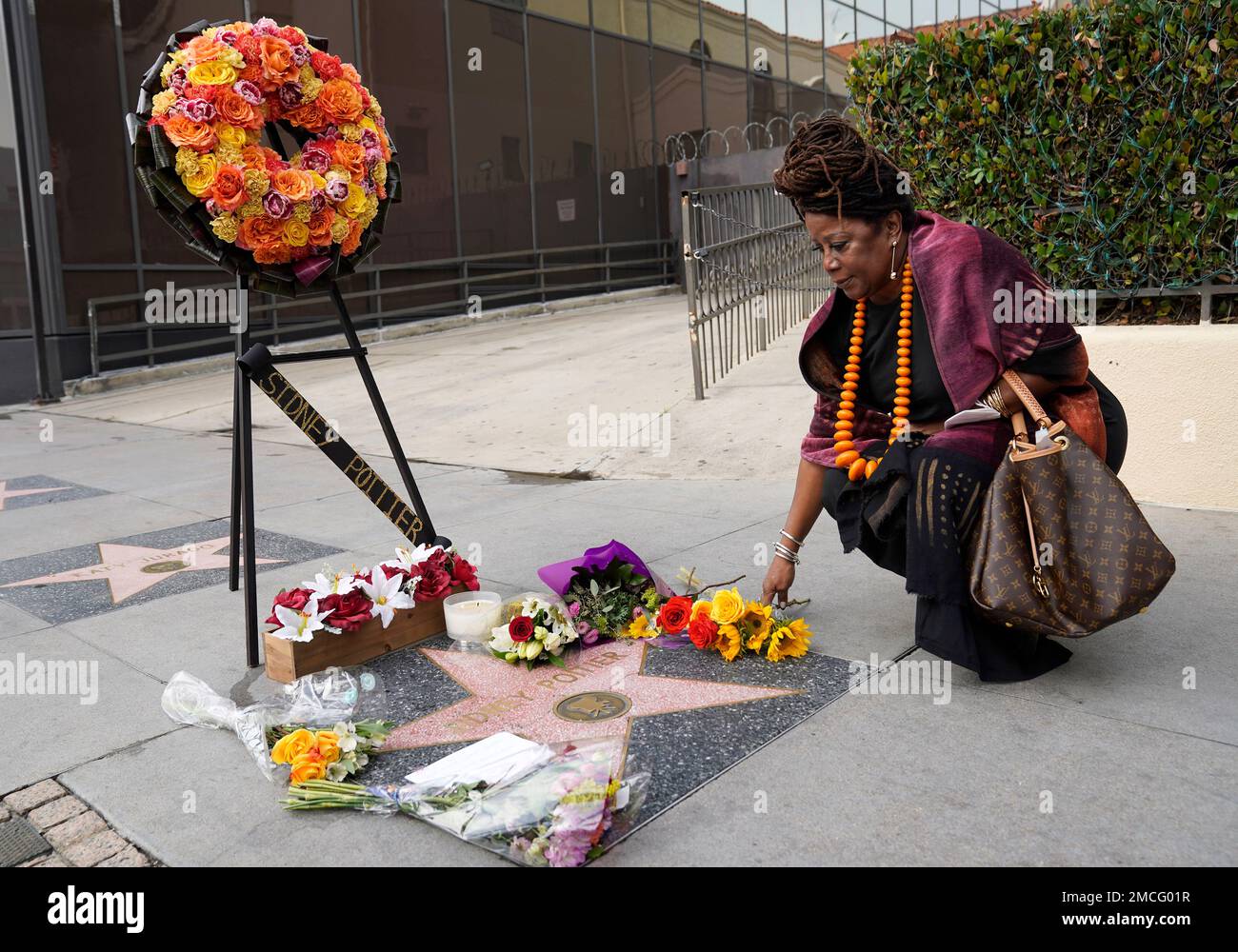 Marie Deary of Long Beach, Calif. lays down flowers at the late actor ...