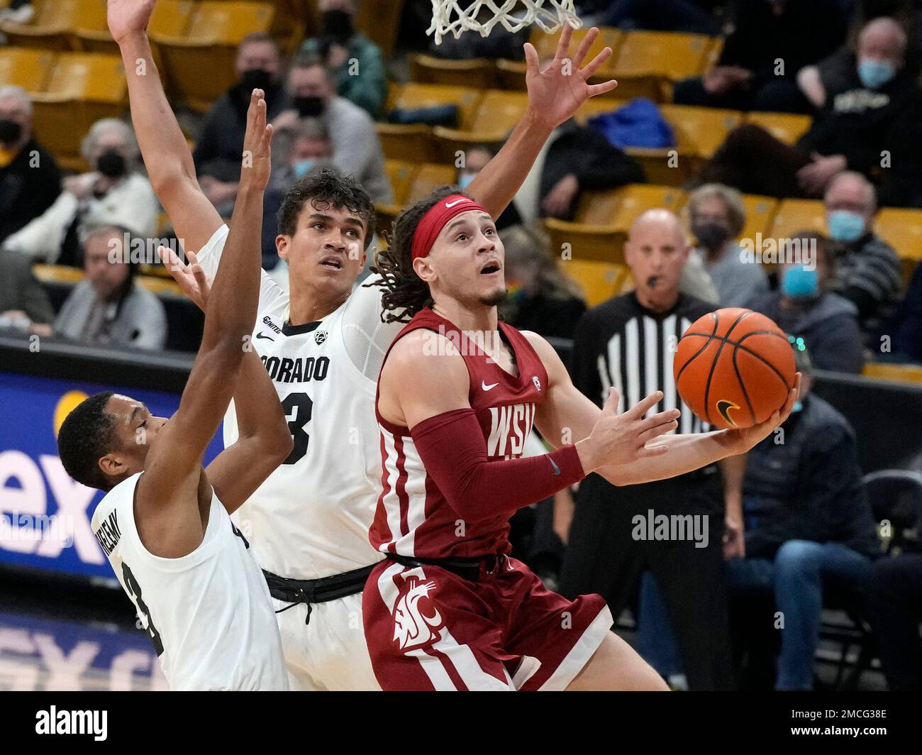 Washington State guard Tyrell Roberts, right, drives to the basket ...