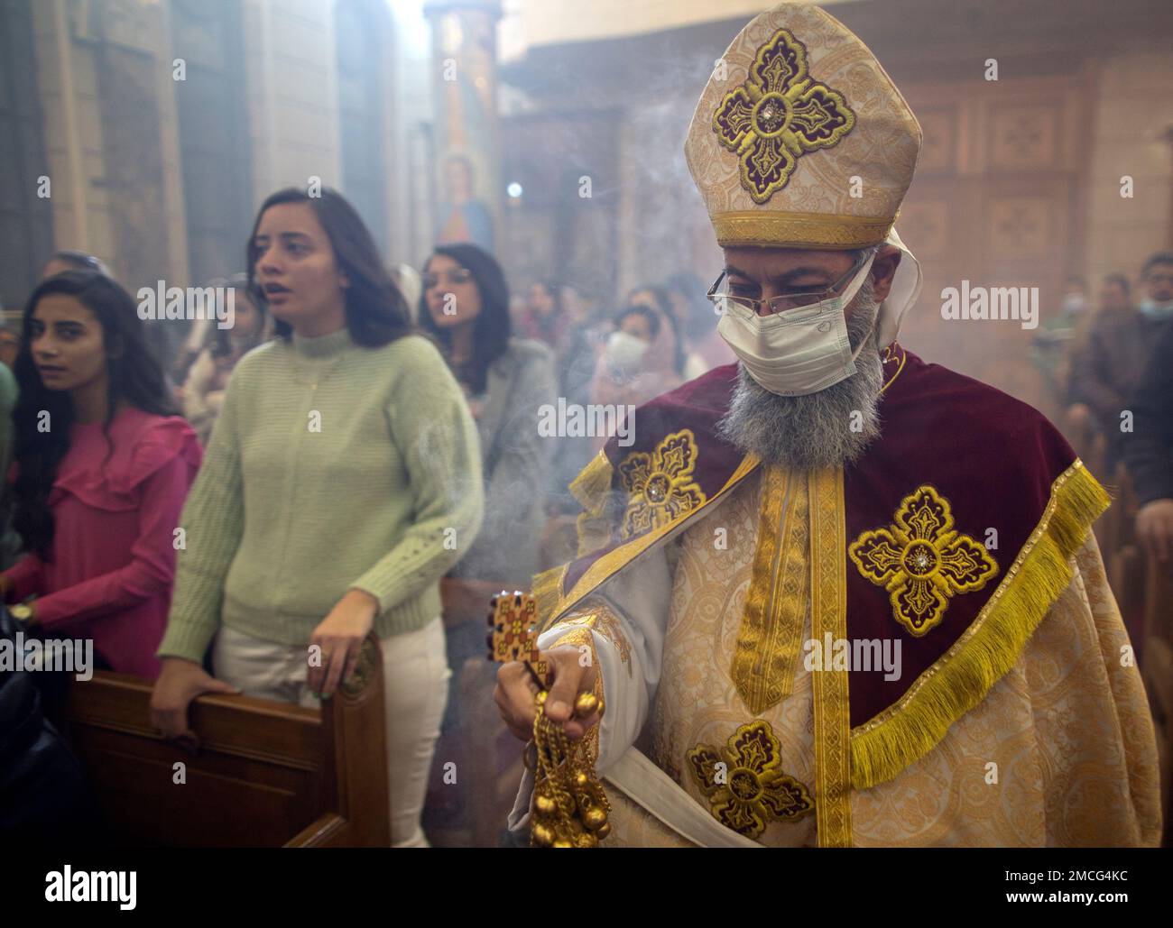 Bishop Dawod Makram wears a face mask, to help prevent the spread of the coronavirus, as he ...
