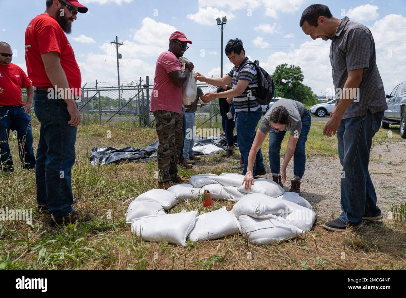 U.S. Army Corps of Engineers flood fight team members build a ring ...