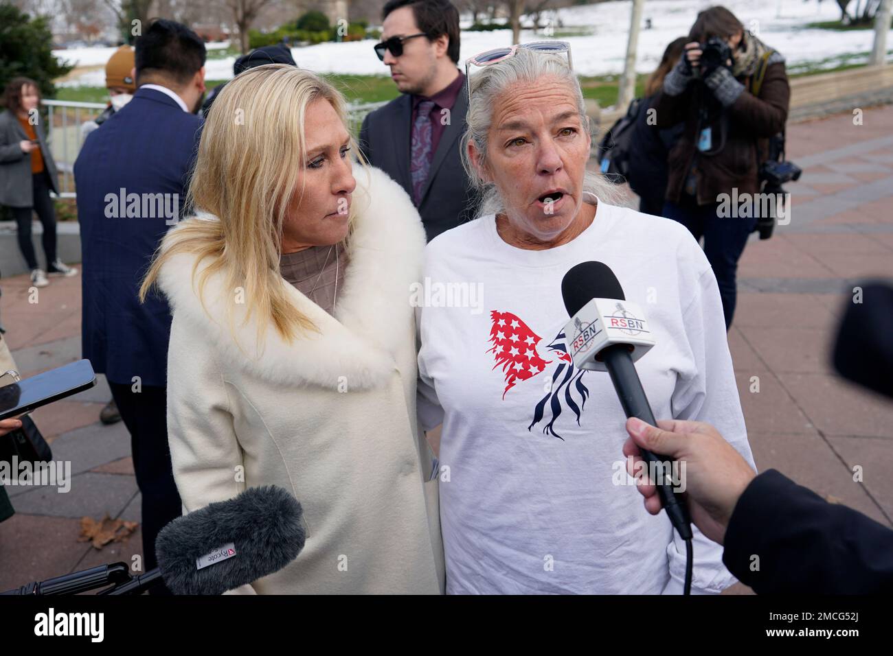 Rep. Marjorie Taylor Greene, R-Ga., left, stands with her arm around ...