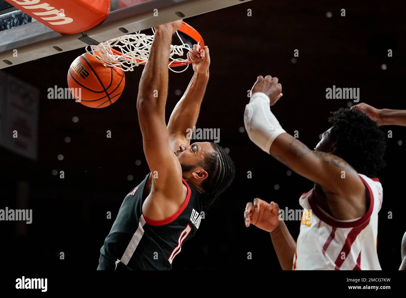 Texas Tech forward Kevin Obanor (0) dunks the ball ahead of Iowa State ...